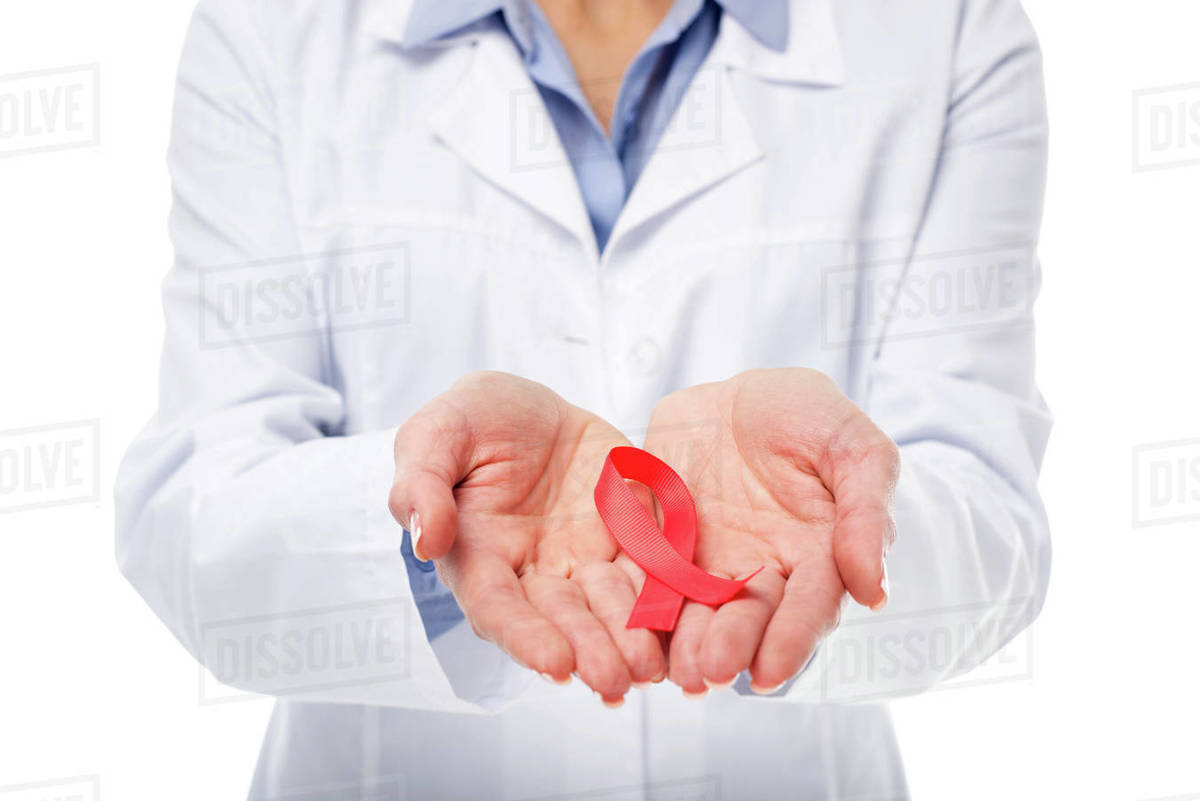 Cropped shot of female doctor with aids ribbon in hands isolated on ...
