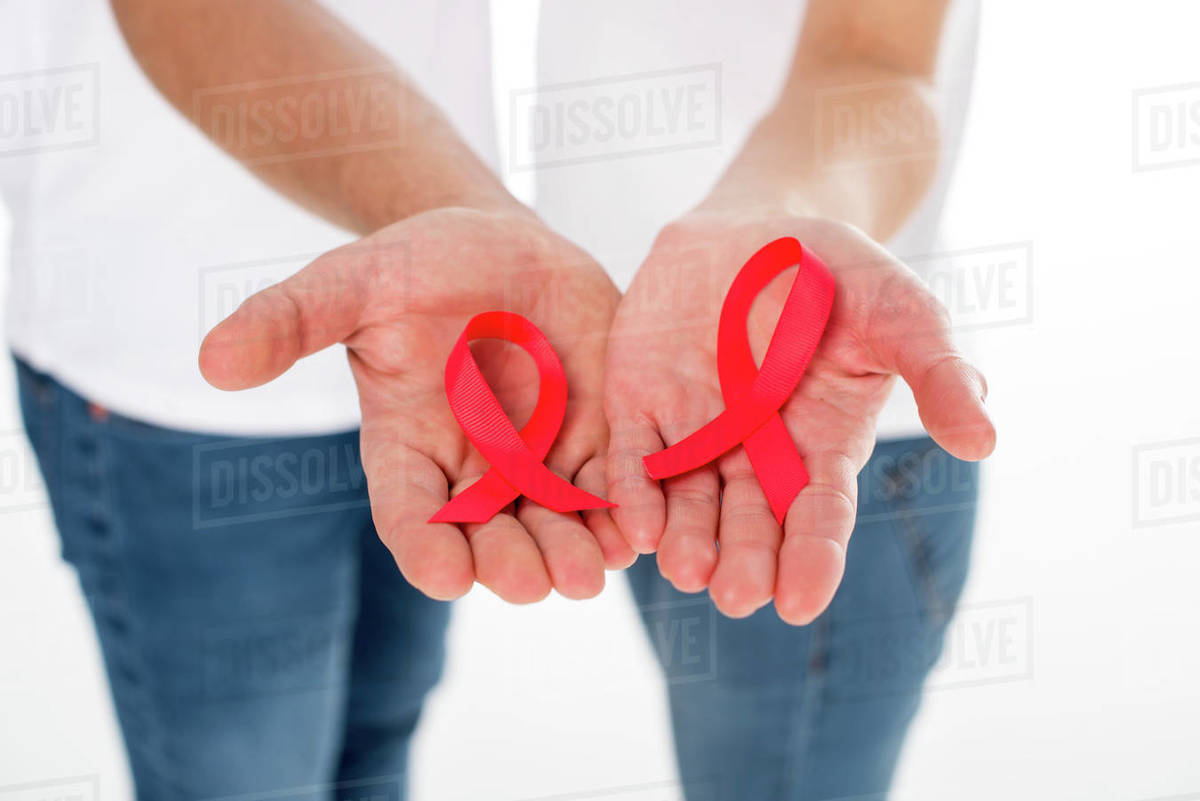 Cropped shot of couple with aids ribbons in hands isolated on white ...