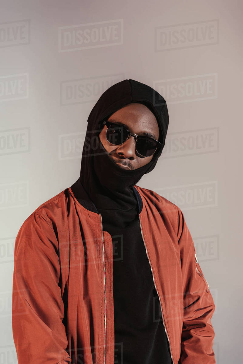 Stylish young african american man wearing hood with face mask isolated ...