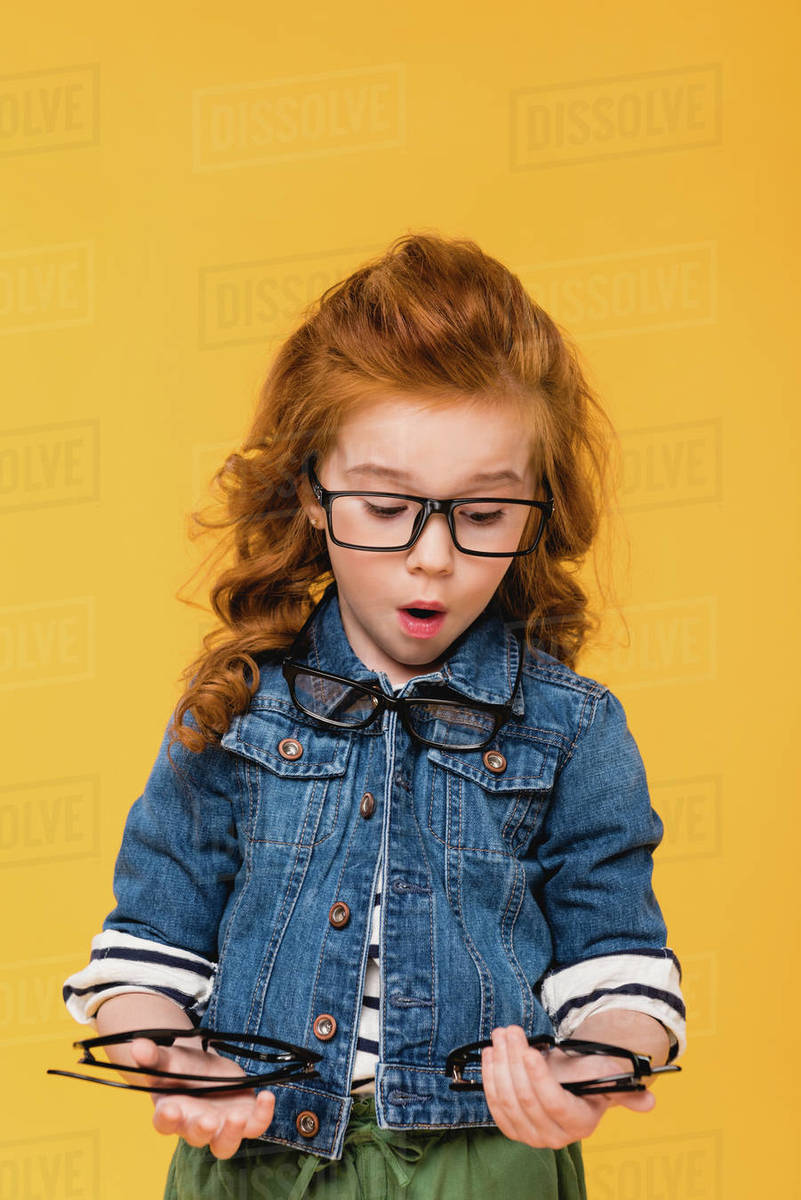 portrait of shocked child with eyeglasses isolated on yellow - Stock ...
