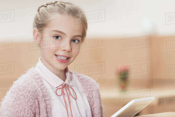 smiling child with digital tablet looking at camera at cafe - Stock ...