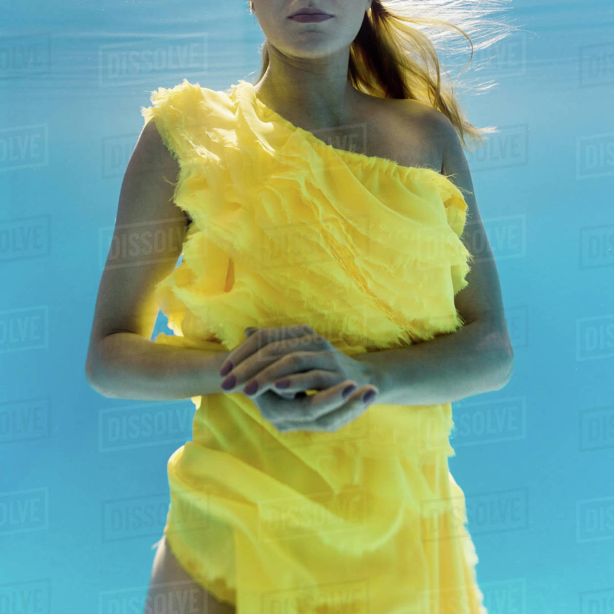 Partial view of woman in dress swimming underwater - Royalty-free Stock ...