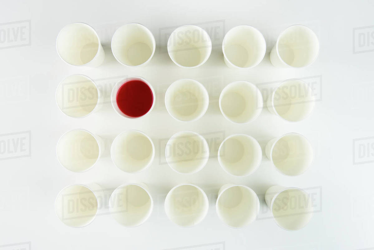 Top view of set of empty plastic cups and one with red paint - Royalty ...