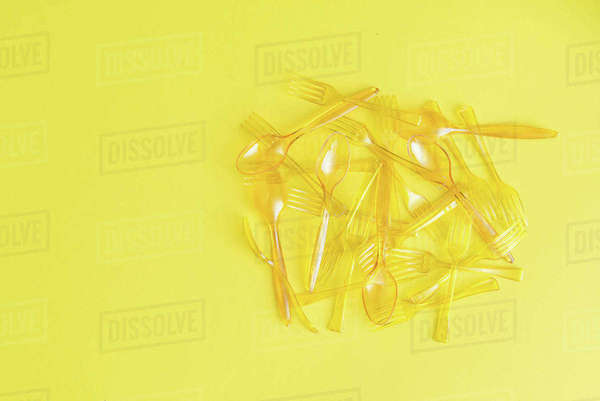 Top view of pile of spoons and forks isolated on yellow - Stock Photo ...