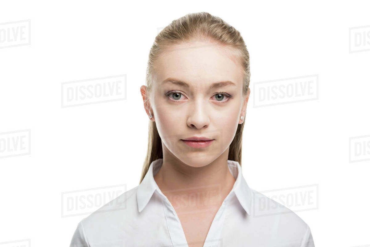 Portrait of pensive Caucasian teenage girl looking at camera isolated ...