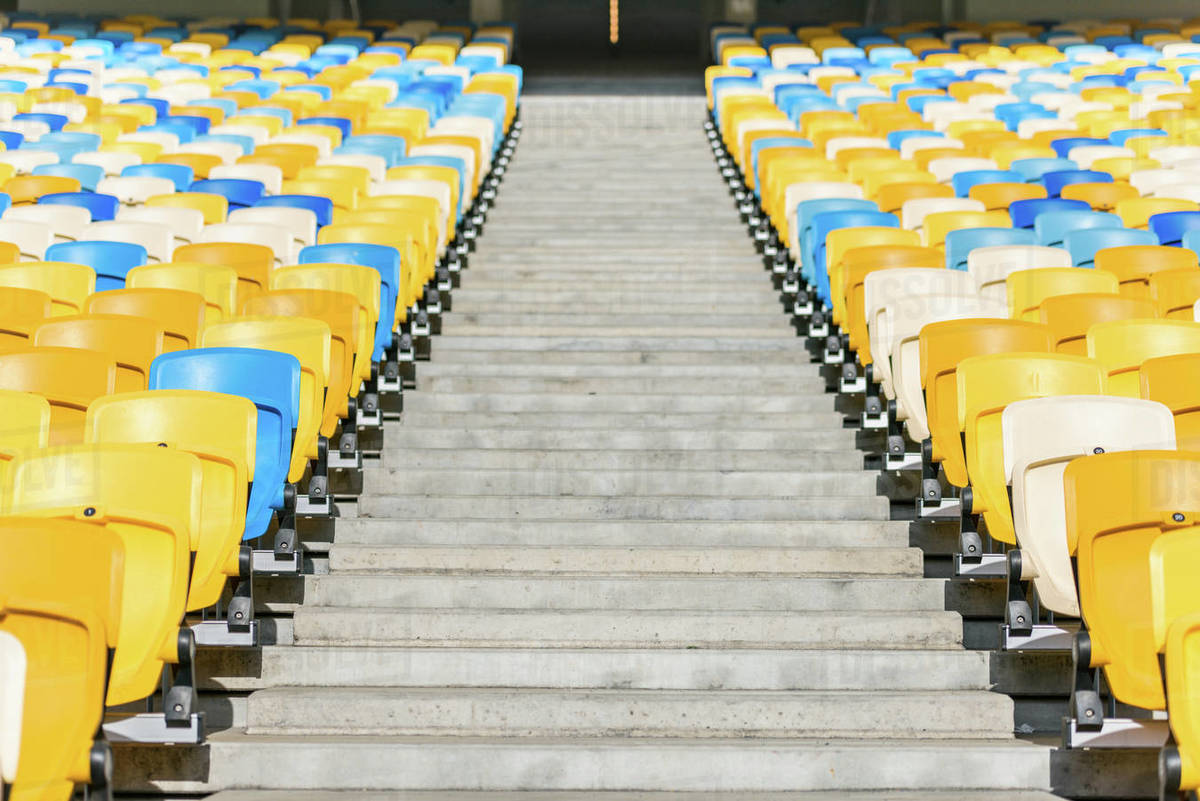 Rows of yellow and blue stadium seats and stadium stairs - Stock Photo ...