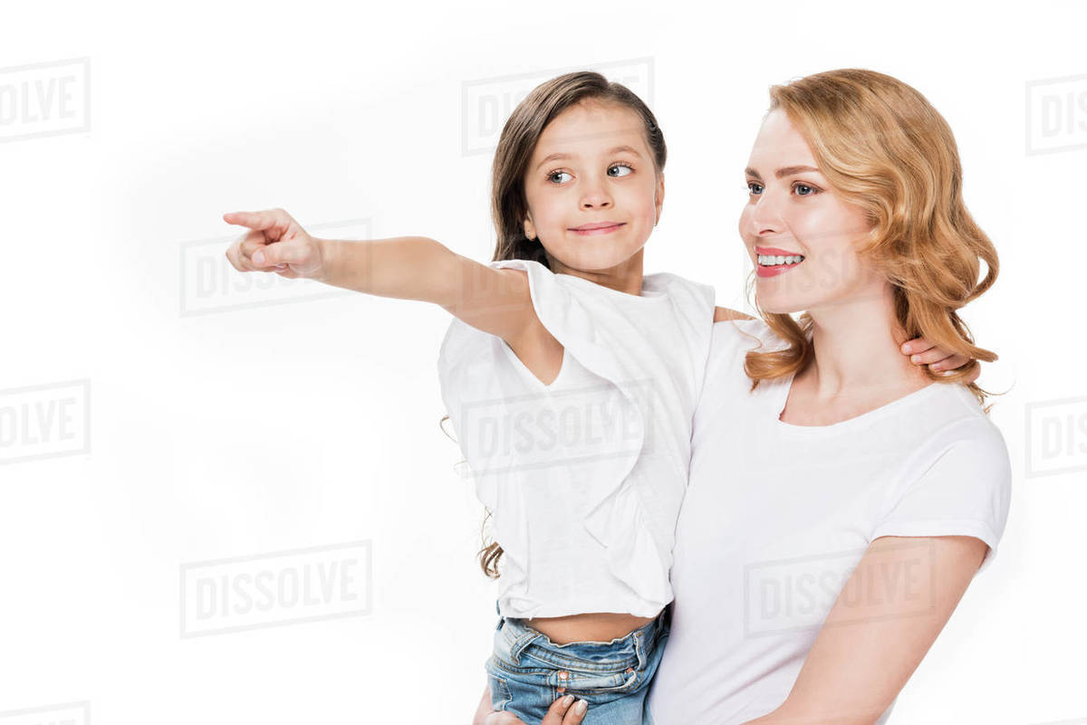 portrait of kid pointing away while showing something to mother ...