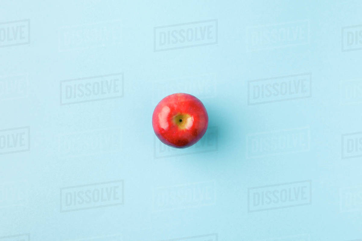 Top view of ripe apple isolated on blue - Stock Photo - Dissolve