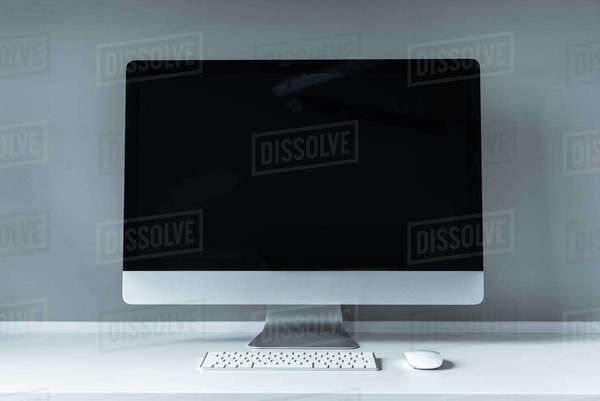 computer with black screen and keyboard on table - Stock Photo - Dissolve