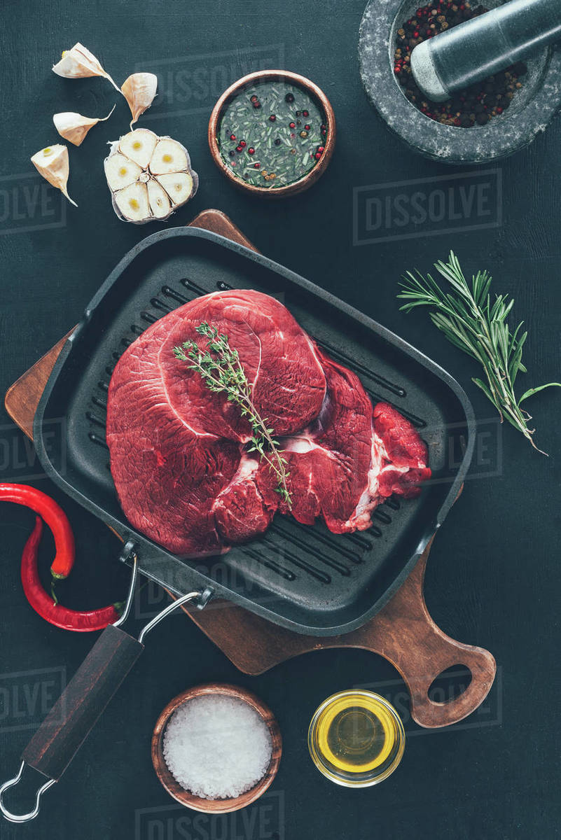 Top view of steak on grill pan with various spices around - Royalty ...
