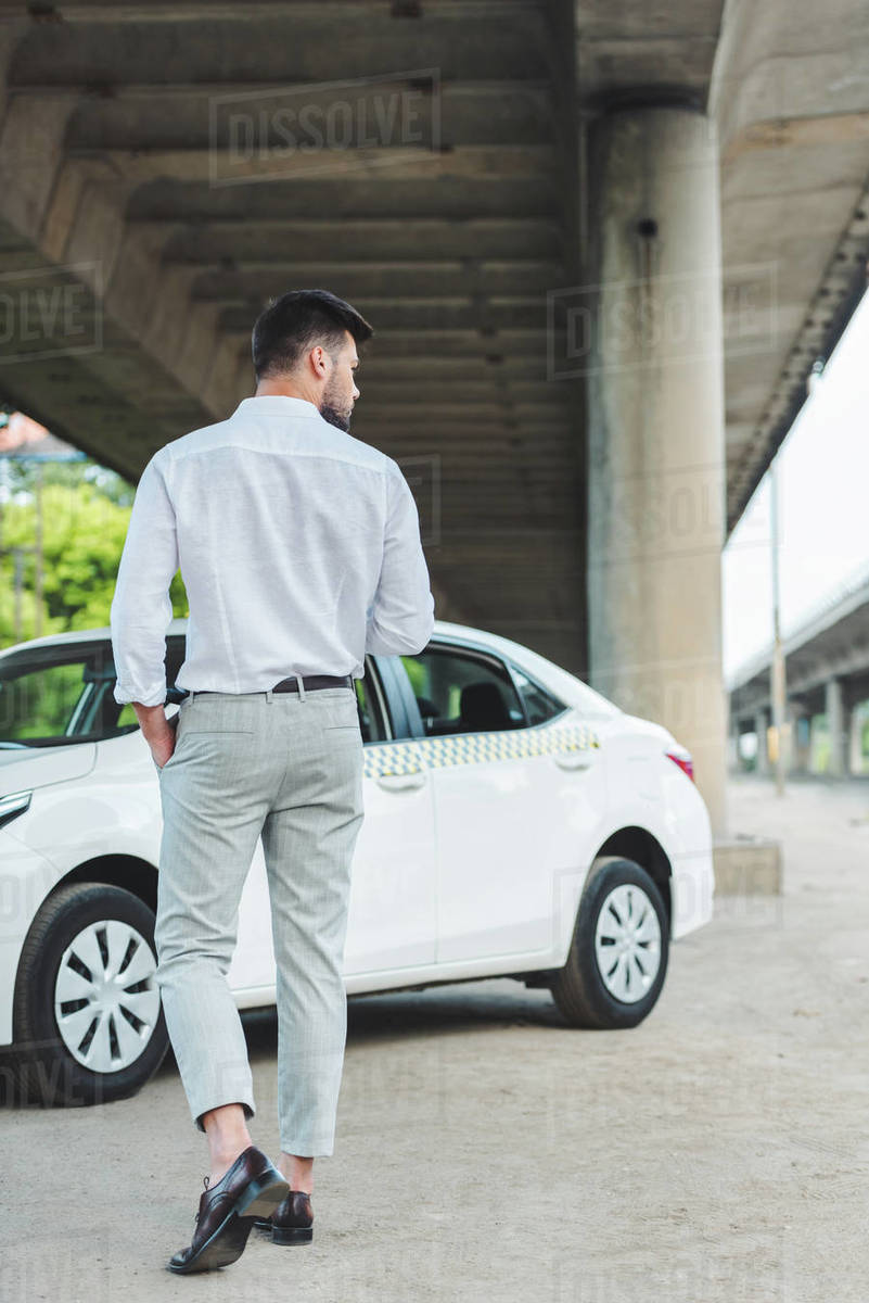 Back view of young man going to the taxi cab - Royalty-free Stock Photo ...
