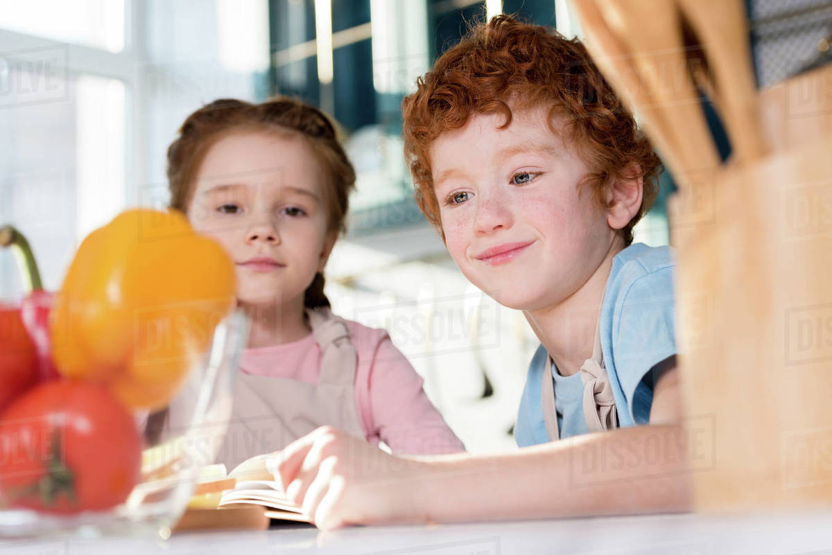 Selective focus of cute little kids cooking together in kitchen - Stock ...