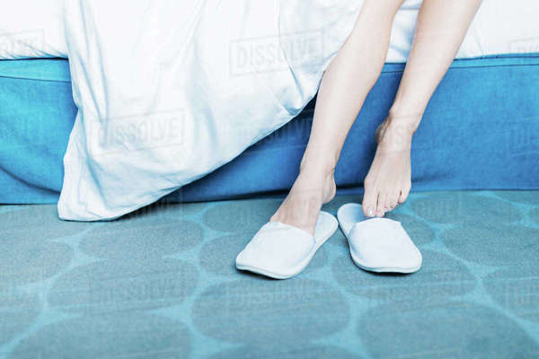 cropped image of girl wearing slippers in morning - Royalty-free Stock ...