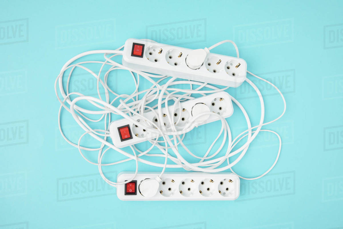 top view of arrangement of extension cords isolated on blue - Stock ...