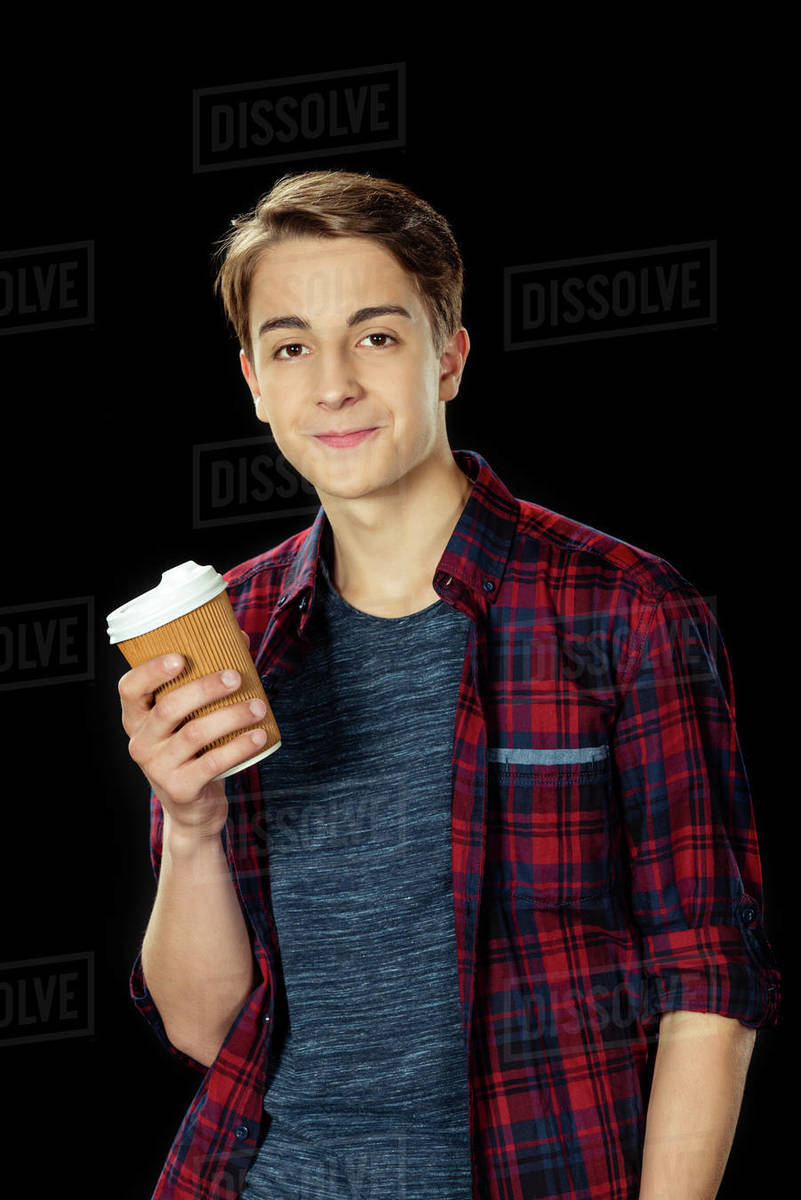 Teen boy with cup of coffee to go isolated on black - Royalty-free ...