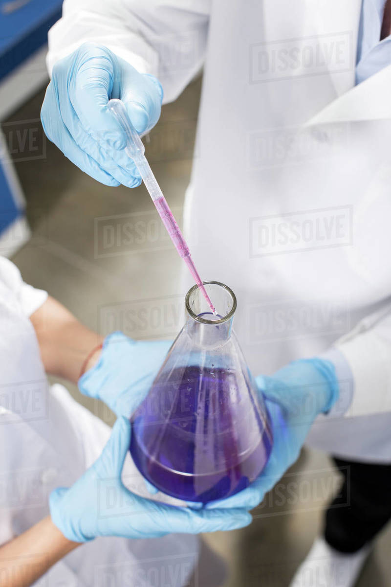 Partial view of scientists making experiment in laboratory - Royalty ...