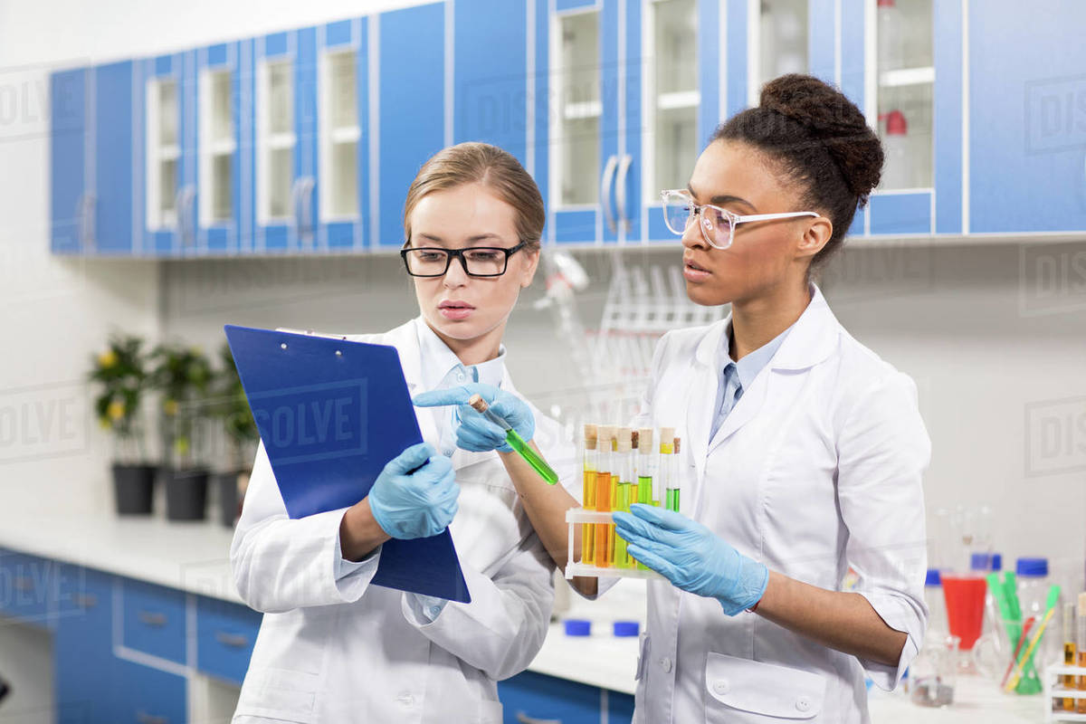 Portrait of scientists working with test tubes, laboratory researcher ...