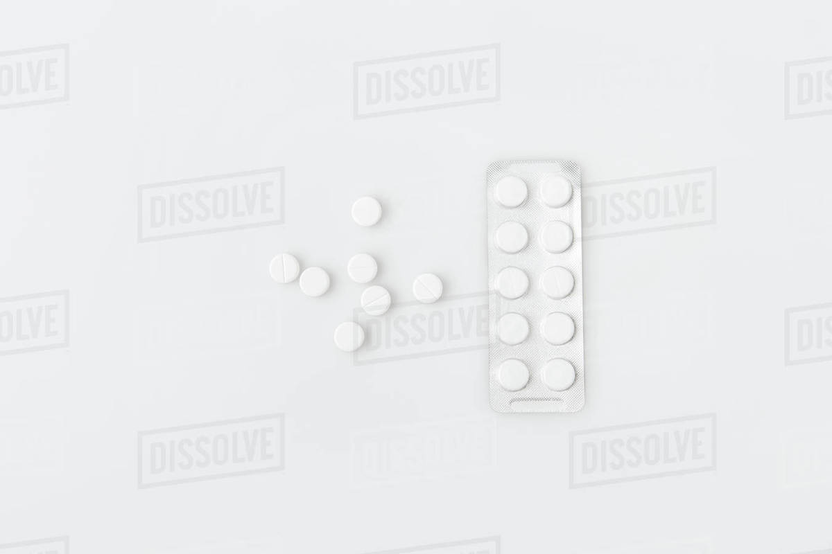 Scattered pills and tablets in package isolated on white background ...