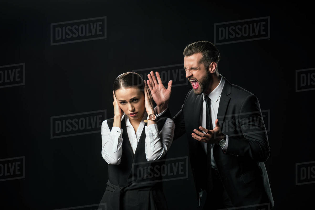 Angry boss yelling at businesswoman, isolated on black - Royalty-free ...