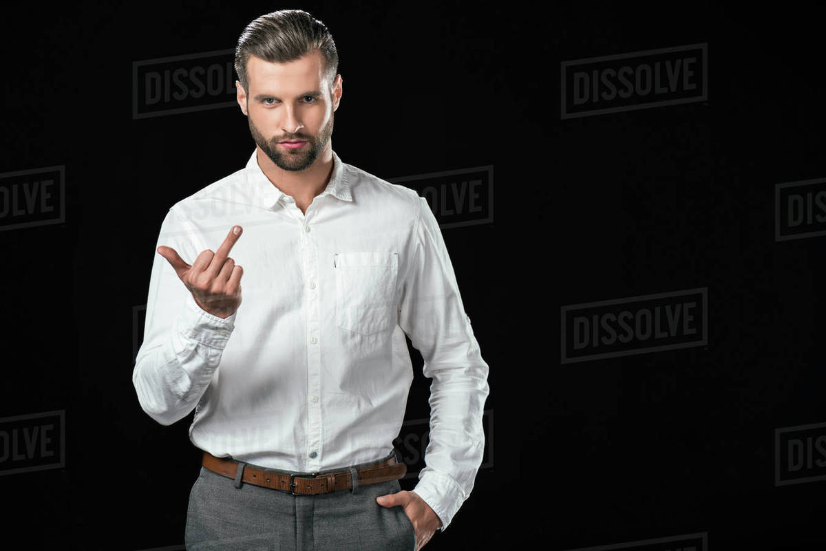 Handsome man showing middle finger, isolated on black - Stock Photo ...