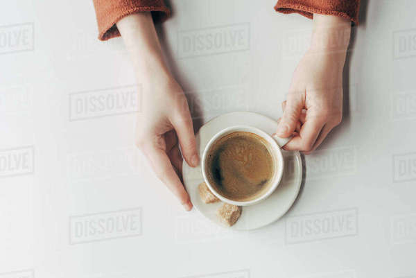 Cropped view of human hands and cup of coffee on grey - Royalty-free ...