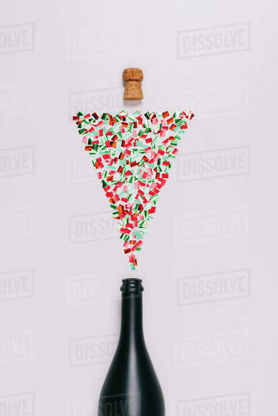Top view of bottle and arranged cork with colorful confetti into ...
