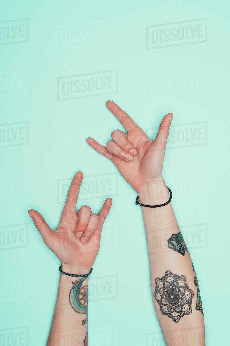 Cropped shot of woman showing horns signs with hands isolated on ...