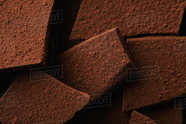 Close up view of heap of chocolate bars in cocoa powder - Royalty-free ...