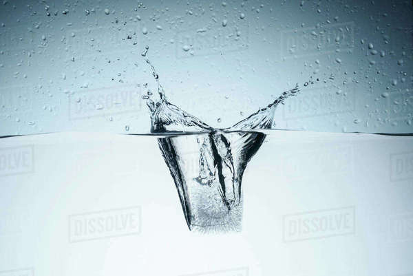 Ice cube in water with splash and drops, isolated on white - Royalty ...