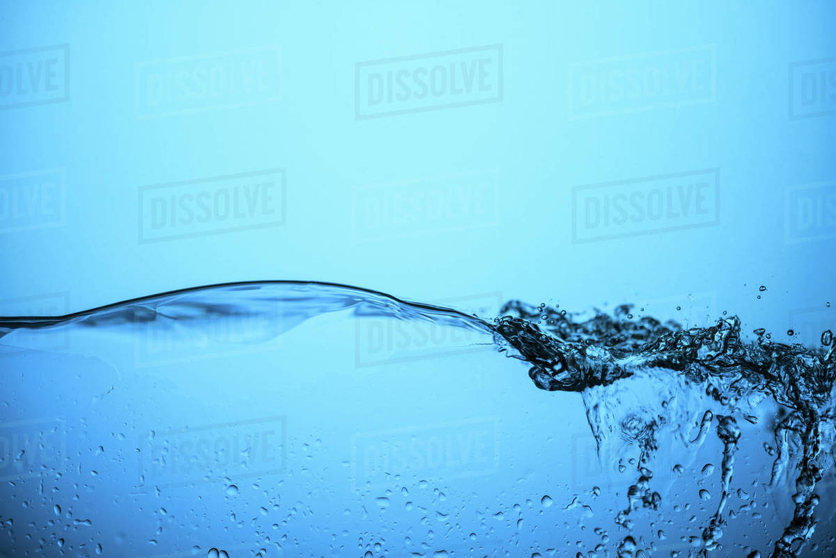 Flowing water texture with bubbles and drops, isolated on blue - Stock ...