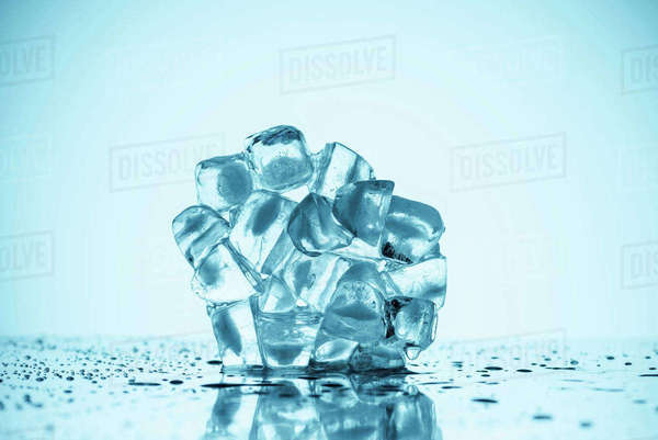 Melting ice cubes on white with drops - Stock Photo - Dissolve