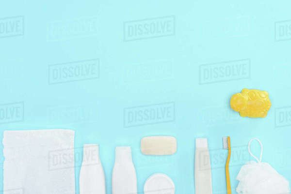 Top view of toy, toothbrush, toothpaste, towel and soap, isolated on ...