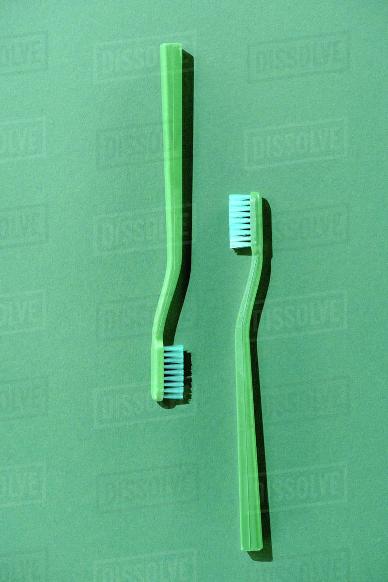 Top view of green toothbrushes, on green - Royalty-free Stock Photo ...