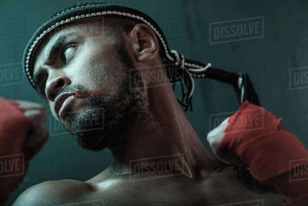 Close-up portrait of determined muay thai fighter with blood on face ...