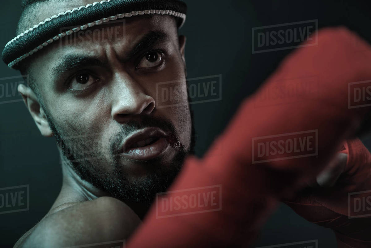 Close-up portrait of aggressive young muay thai boxer training thai ...