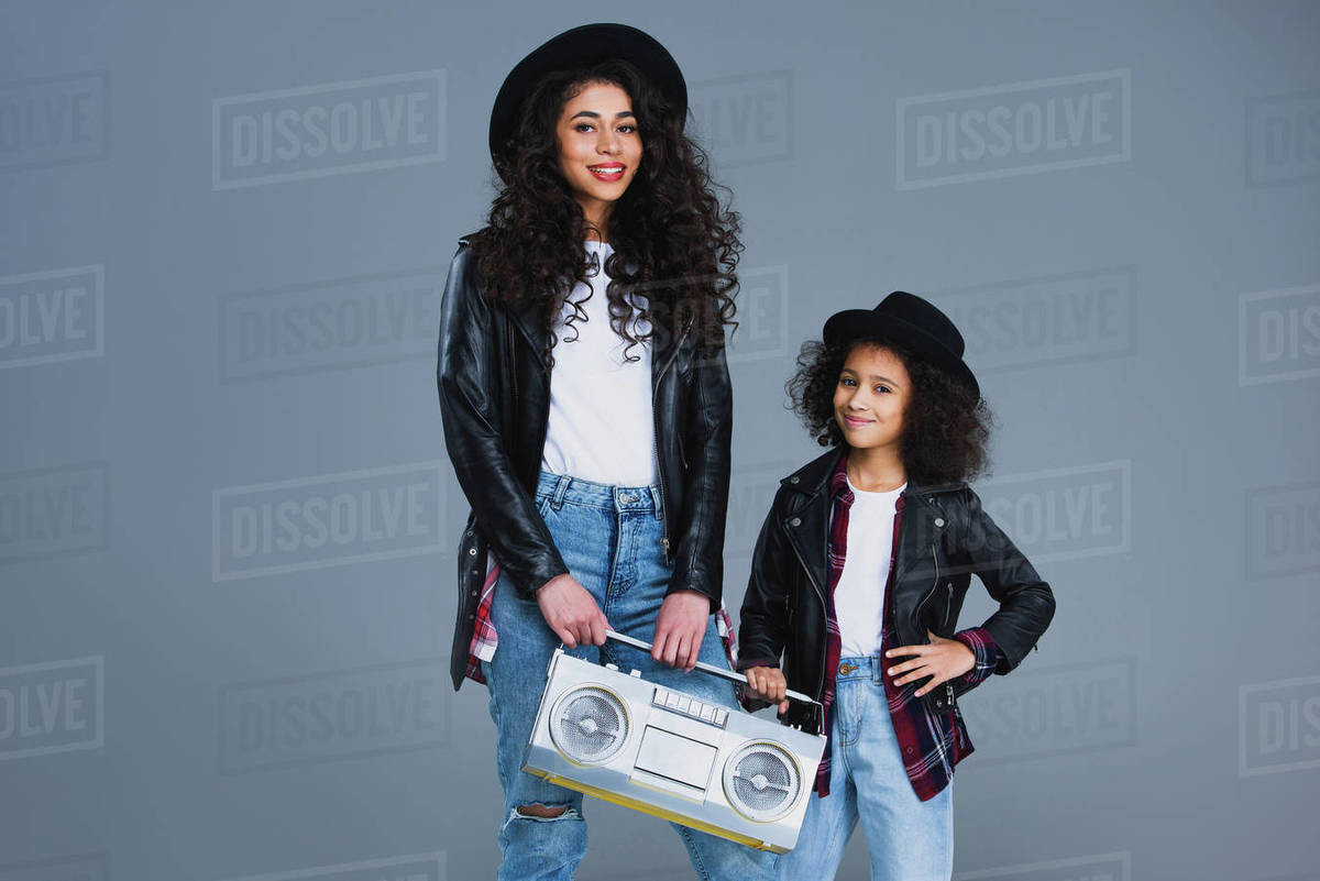 Mother and daughter with retro boom box isolated on grey - Stock Photo ...