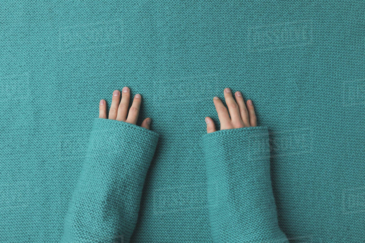 Cropped view of woman hands laying over turquoise fabric - Stock Photo ...