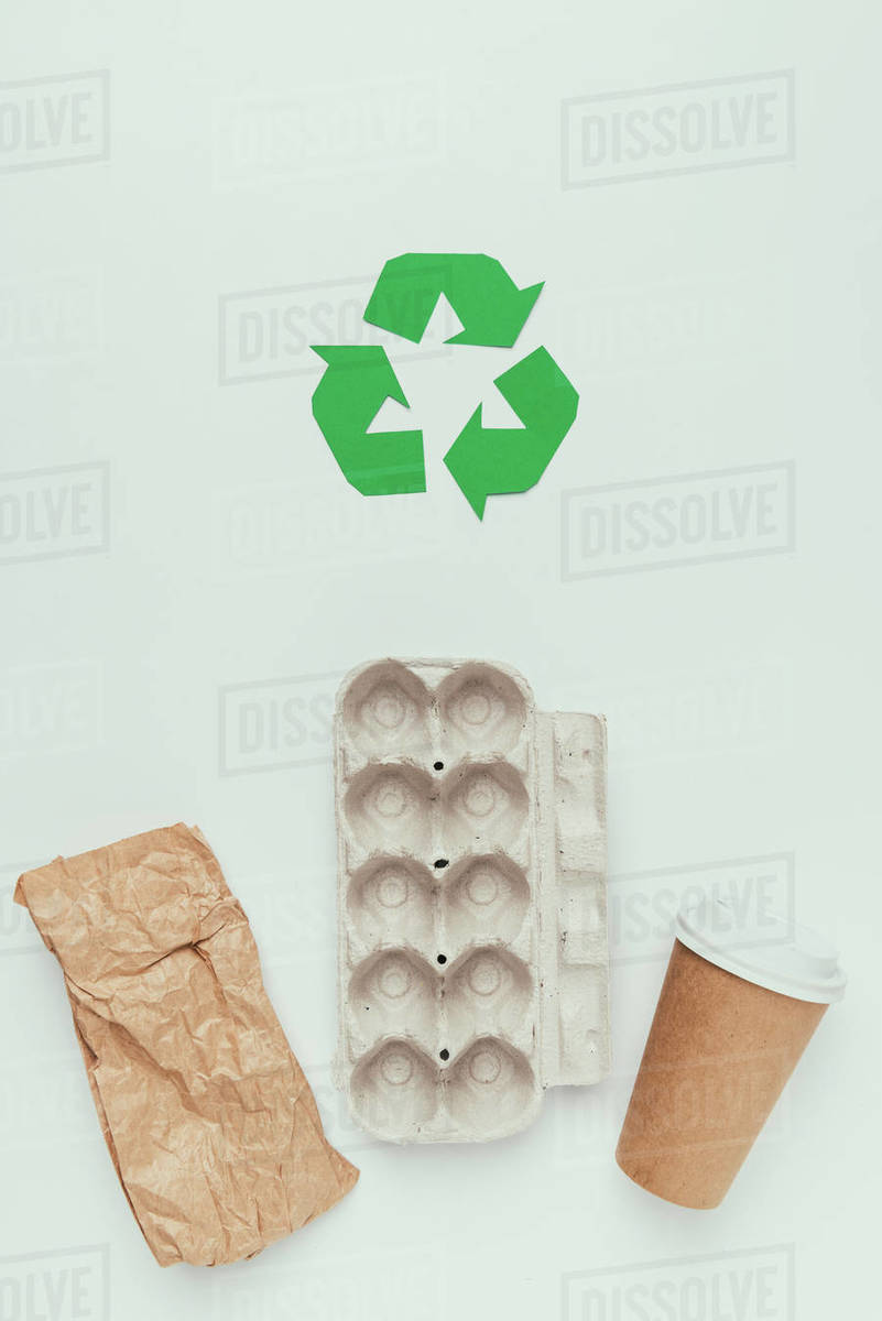 Flat lay with recycle sign and disposable trash isolated on grey ...