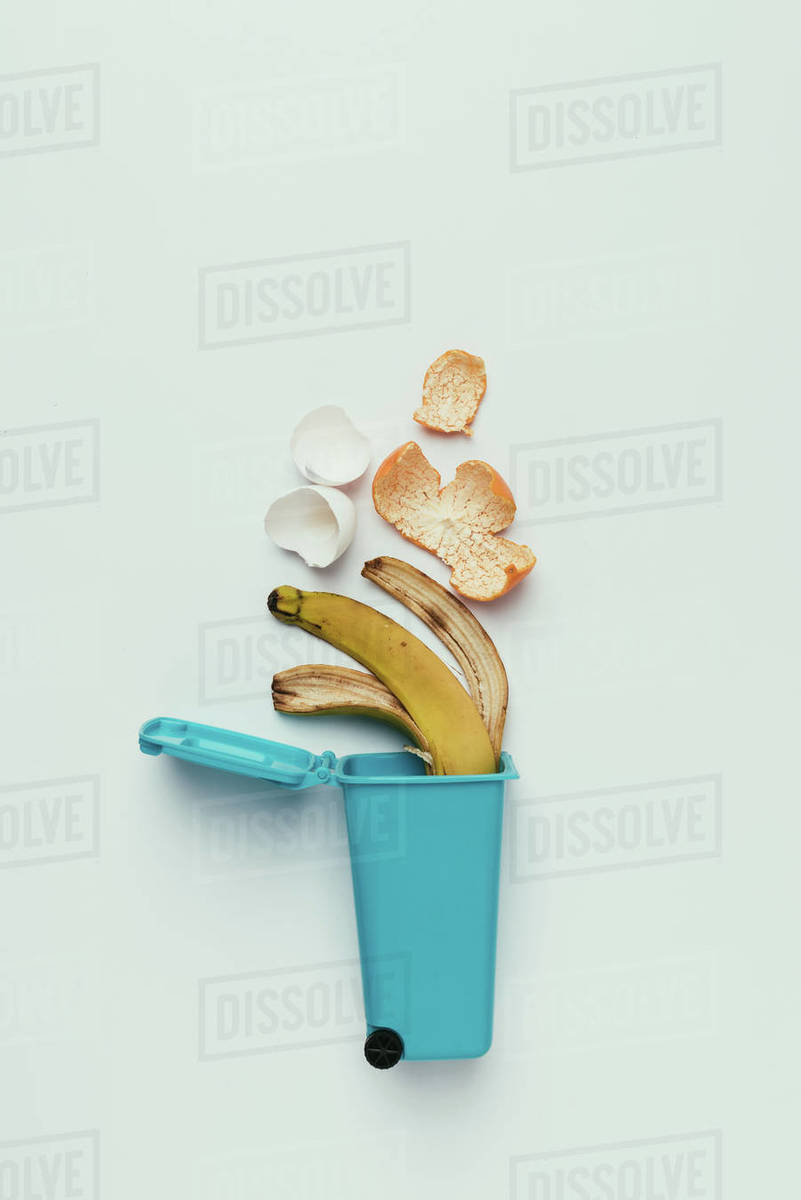 Top view of trash bin with food waste isolated on grey, recycling ...