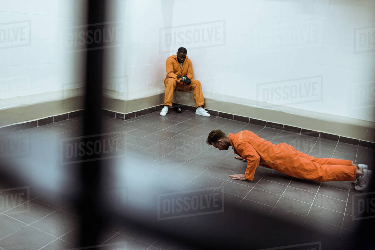 prisoner doing push-ups on floor in prison cell - Royalty-free Stock ...