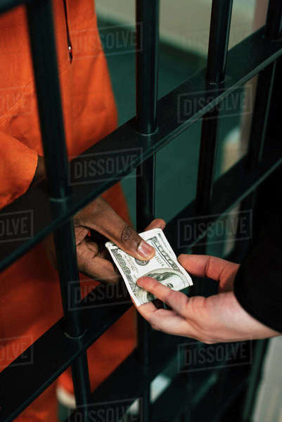cropped image of african american prisoner giving money to prison ...