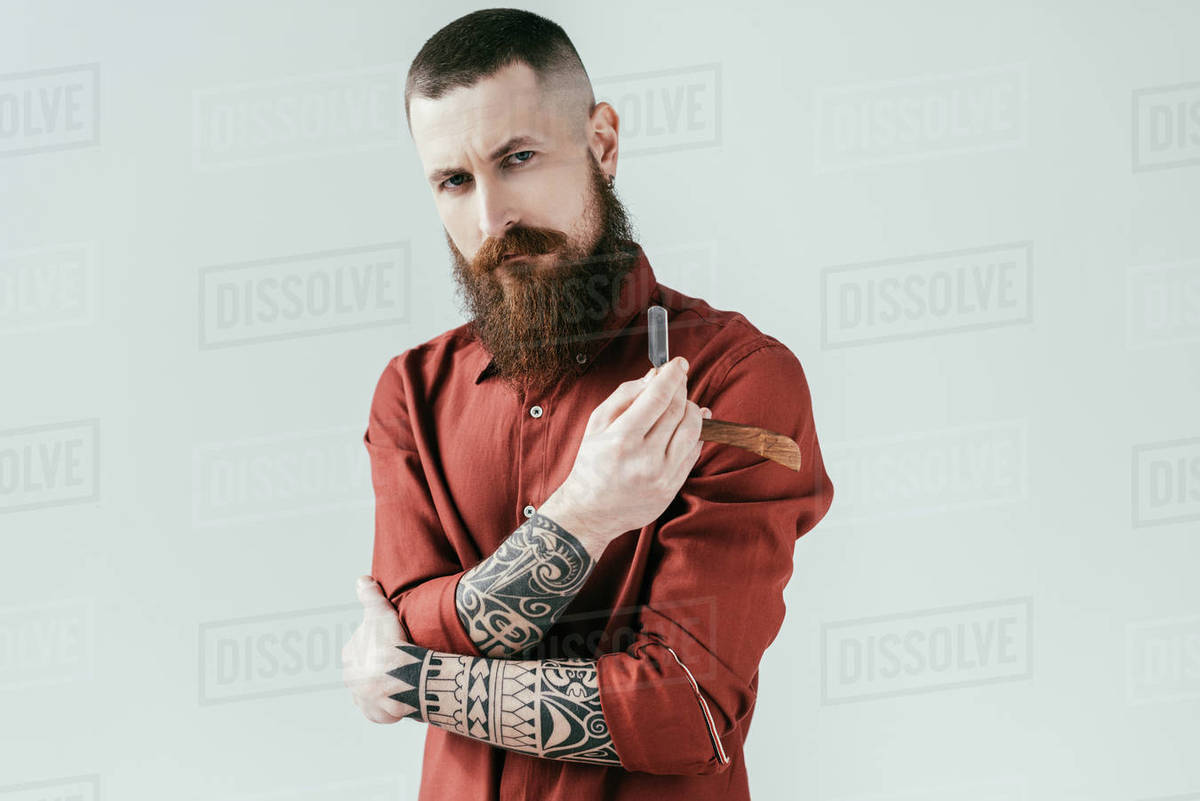 serious handsome barber holding razor isolated on white - Royalty-free ...