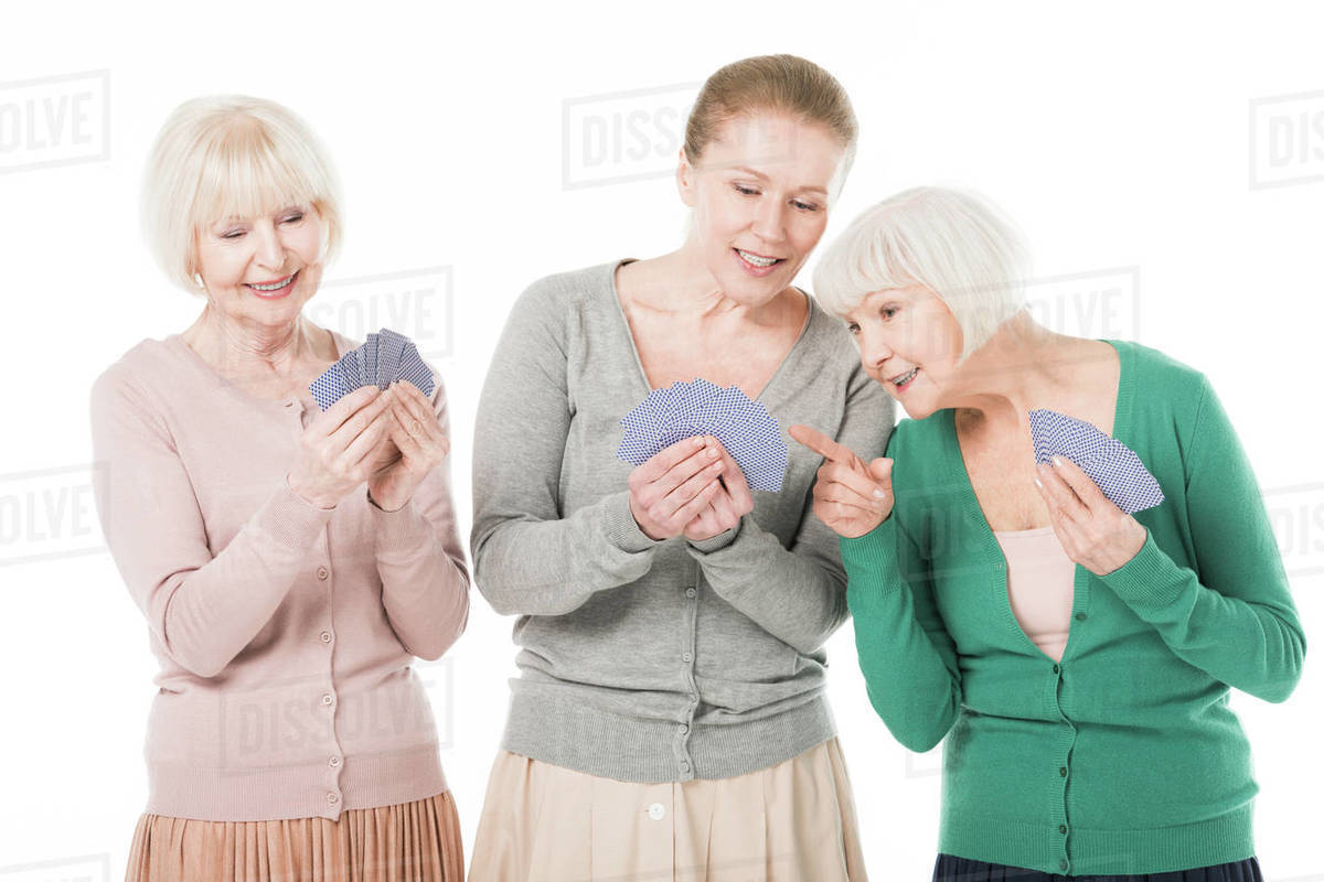 Three stylish smiling women playing cards isolated on white - Stock ...