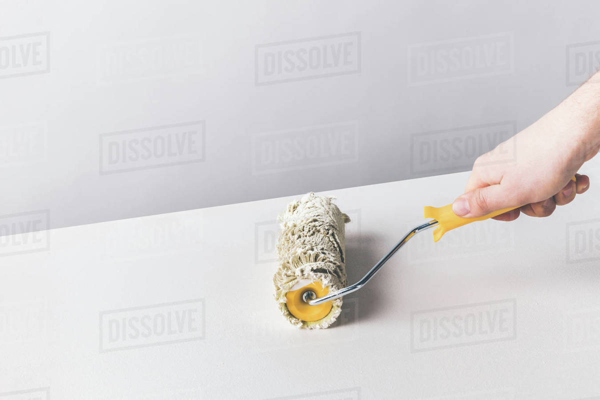 Cropped image of woman painting surface with paint roll brush - Royalty ...