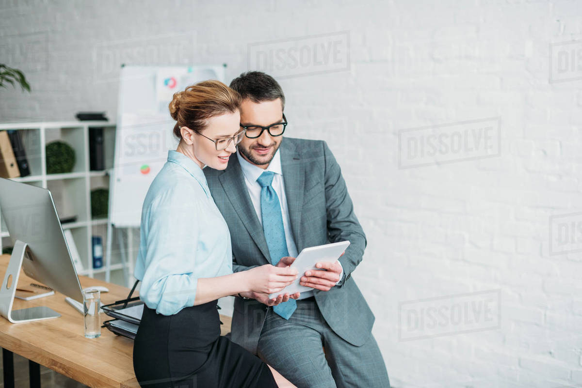 Business partners working with tablet together in office - Royalty-free ...