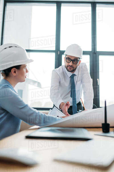 Architects working with building plan at modern office - Royalty-free ...