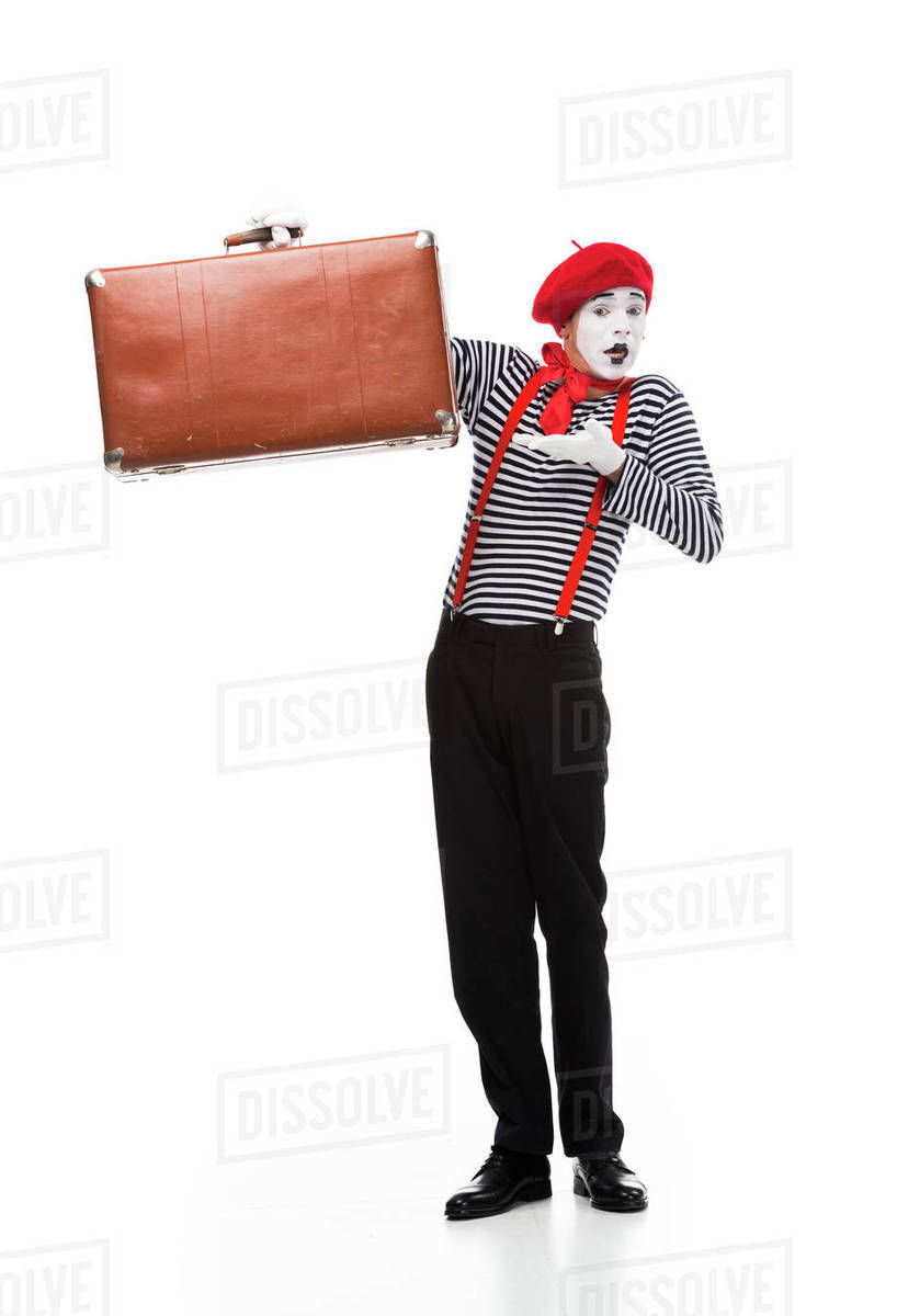 Surprised mime showing at brown suitcase isolated on white - Stock ...