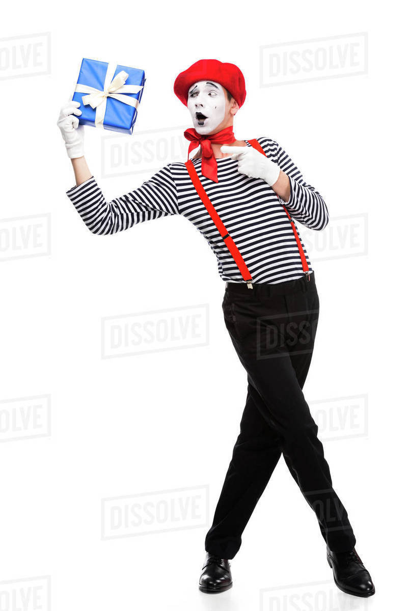 Surprised mime pointing on gift box isolated on white - Stock Photo ...