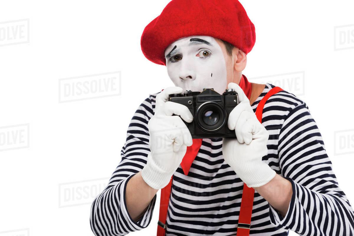 Scared mime taking photo with film camera isolated on white - Royalty ...