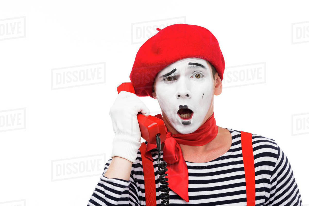 Shocked mime talking by stationary telephone isolated on white ...